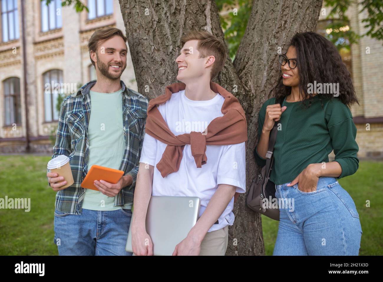 Pretty woman standing near tree hi-res stock photography and images - Alamy