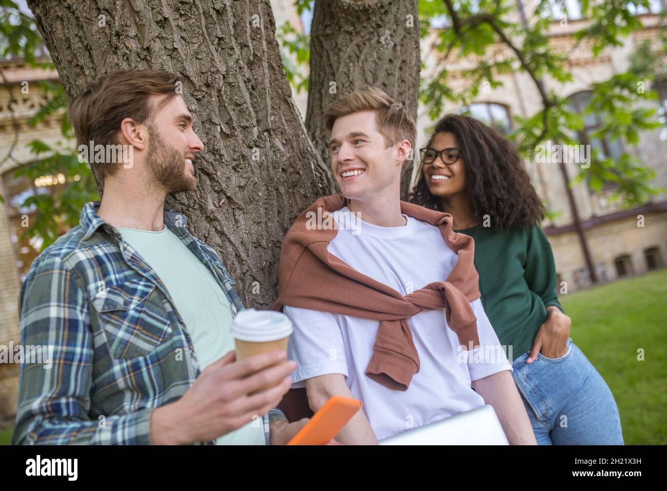 Pretty woman standing near tree hi-res stock photography and images - Alamy