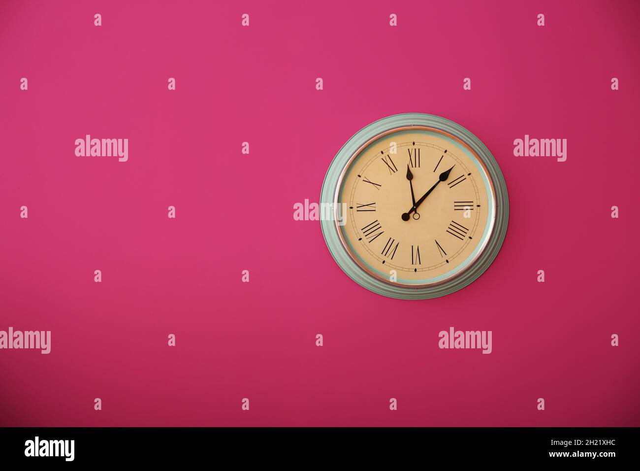 Stylish clock on color wall. Time concept Stock Photo - Alamy