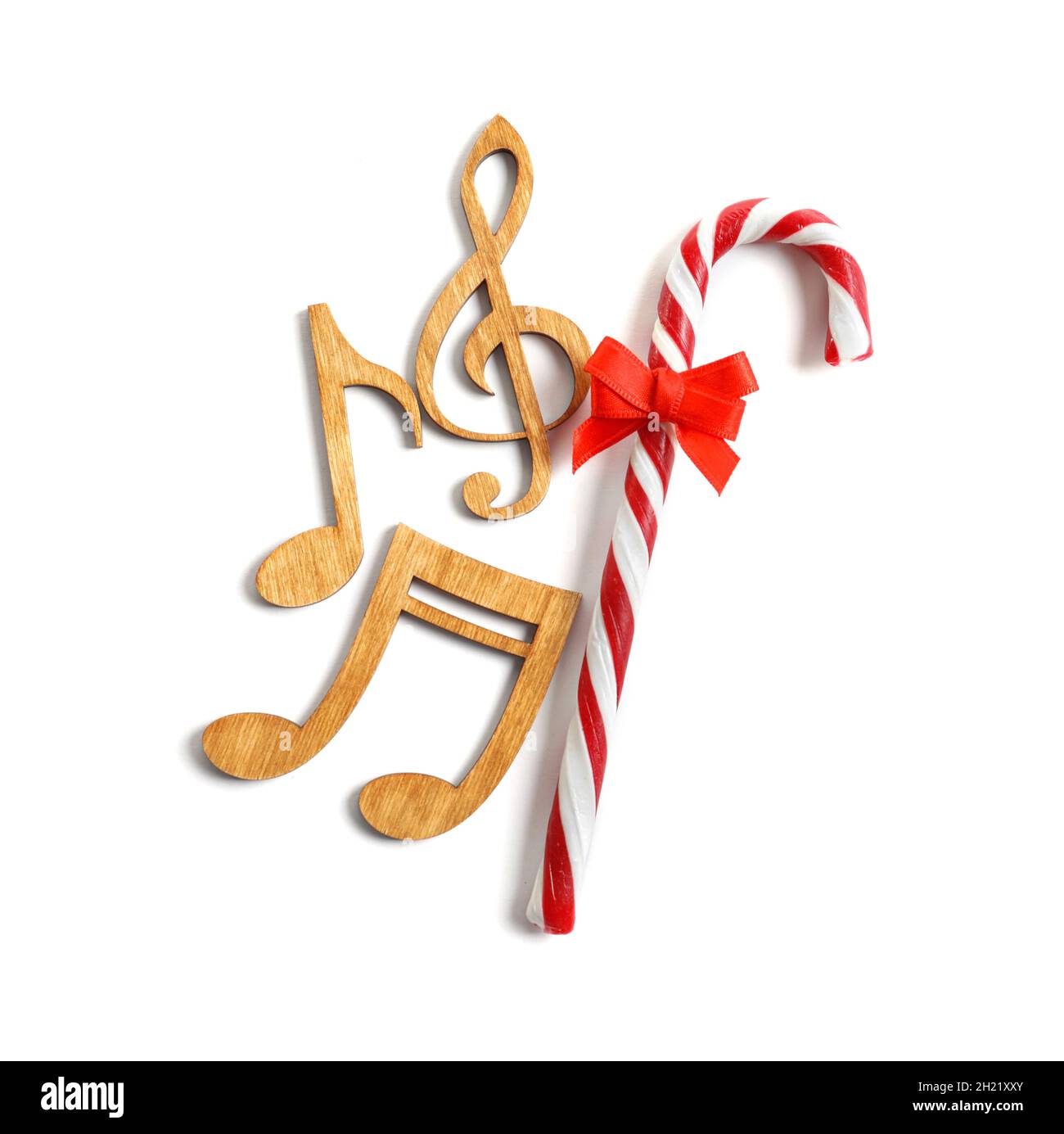 Wooden treble clef, notes and candy cane on white background. Christmas ...
