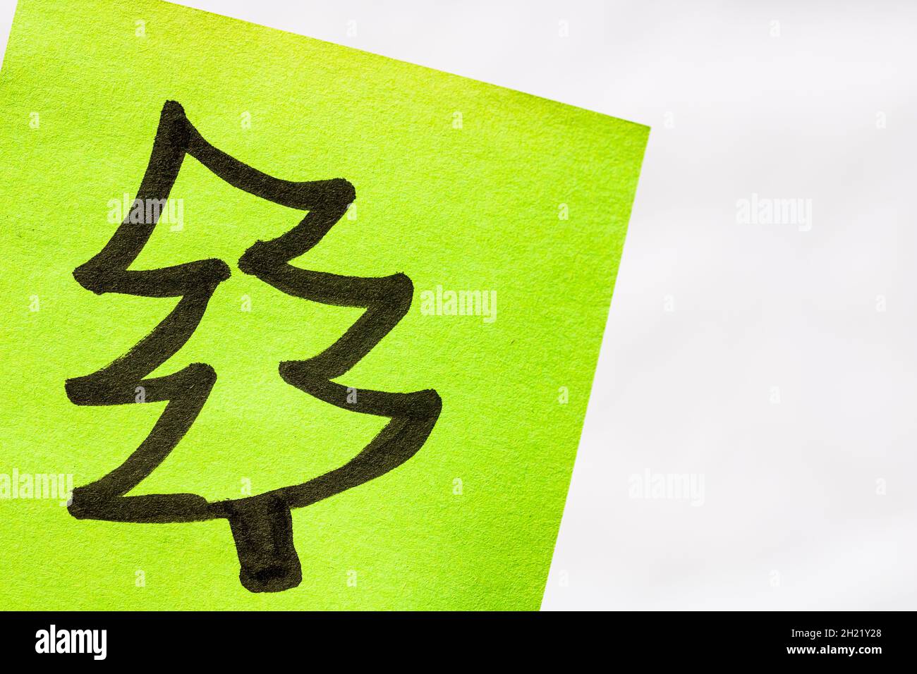 Selective focus of handwritten sticky notes with a Christmas tree ...