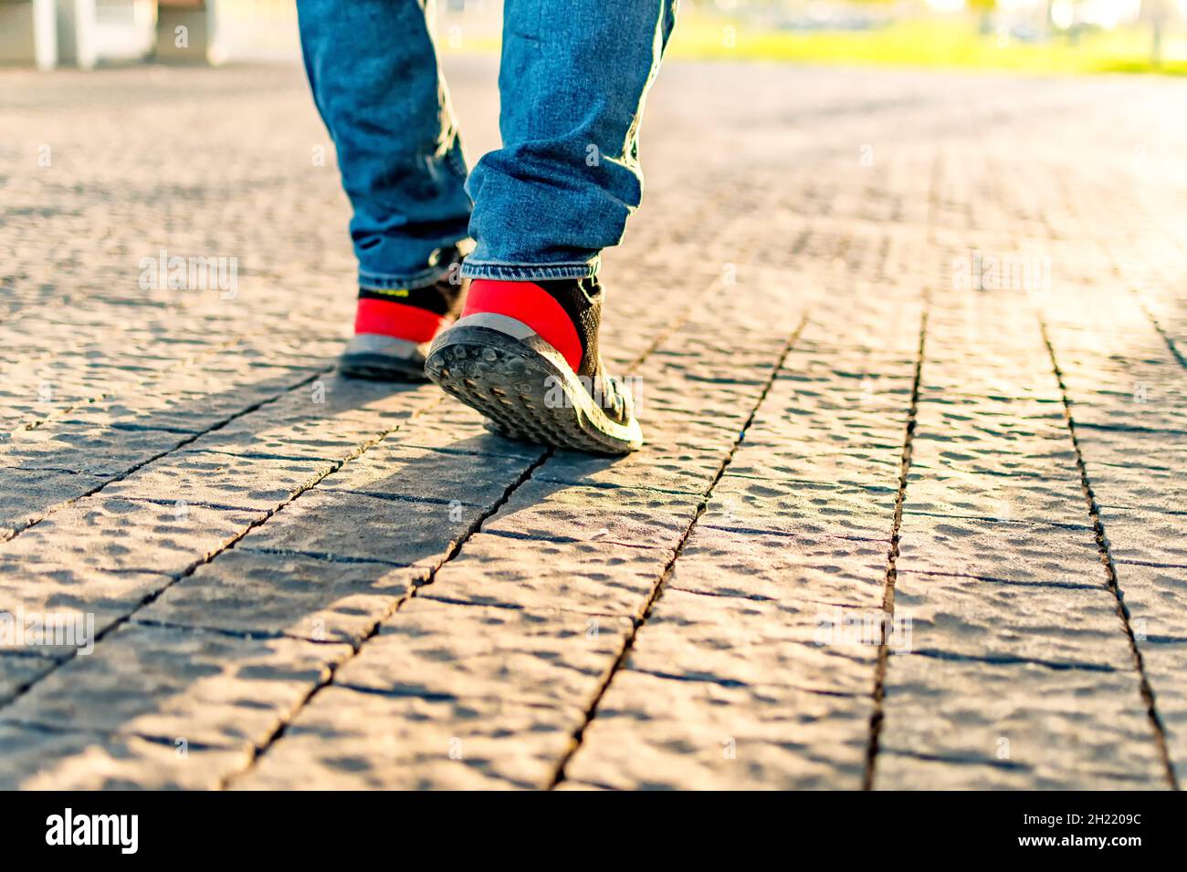 Closeup shot of a male wearing sneakers walking on the street Stock ...