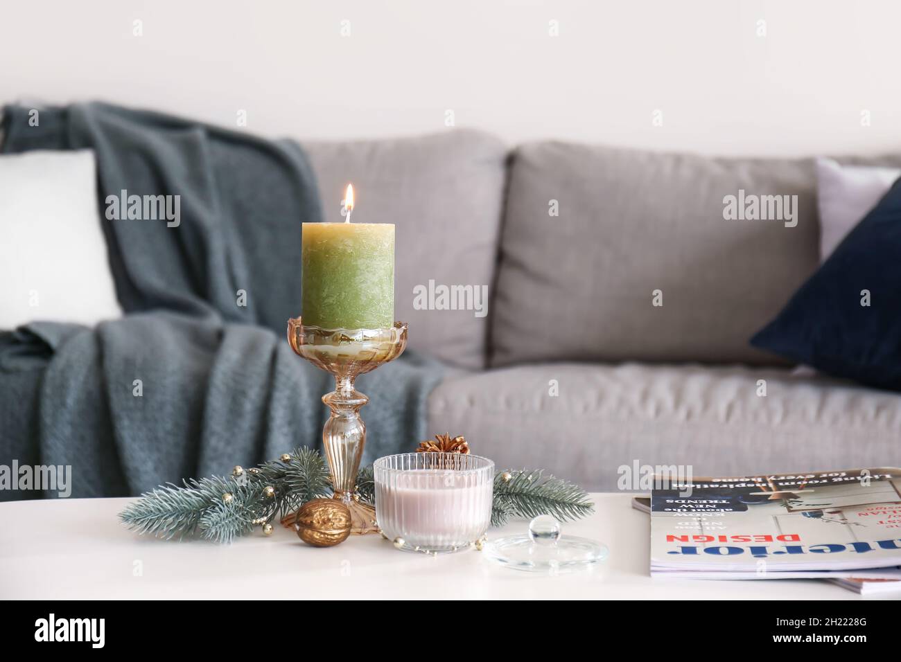 Aroma candles with Christmas decor on table in room Stock Photo - Alamy