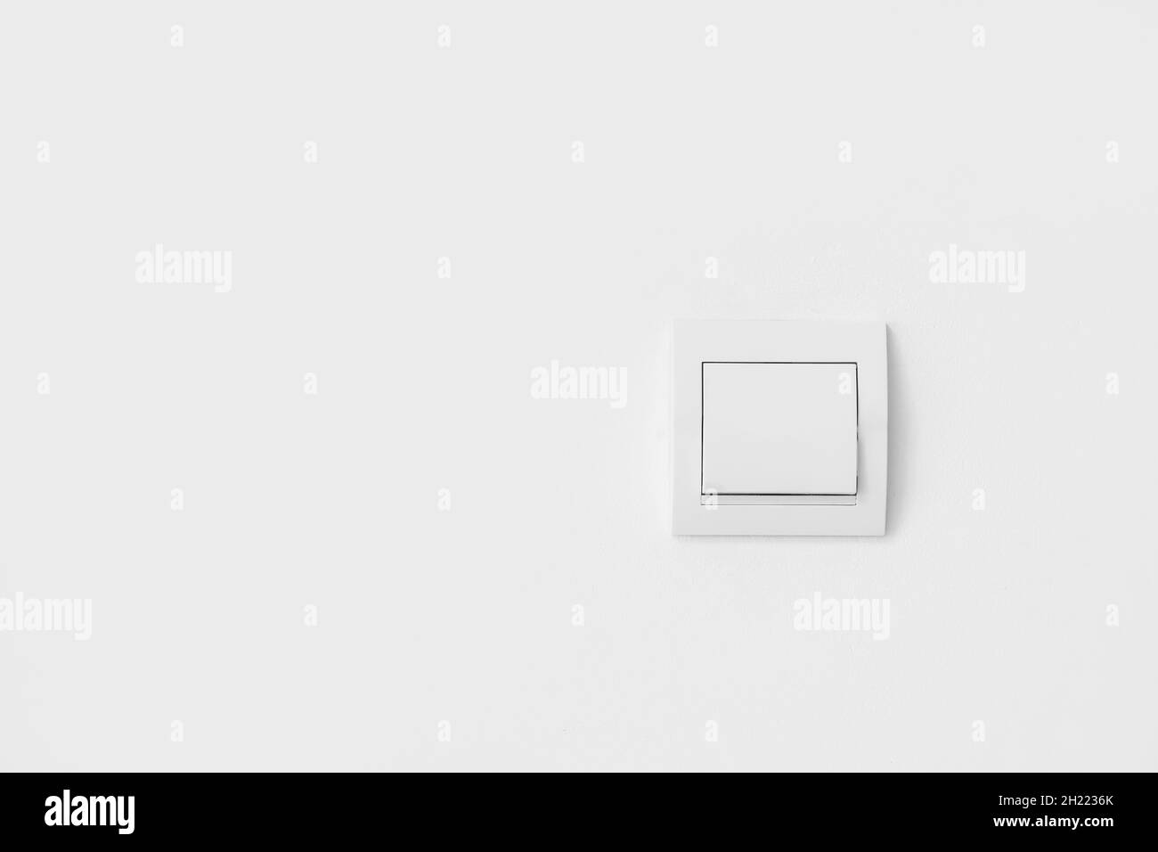 Modern switch on white wall Stock Photo - Alamy