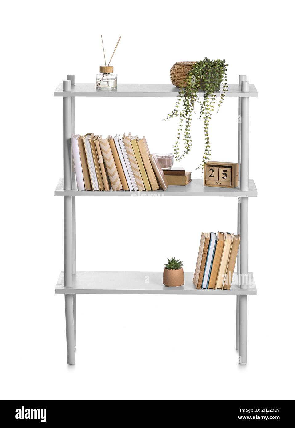 Modern bookcase with decor on white background Stock Photo - Alamy