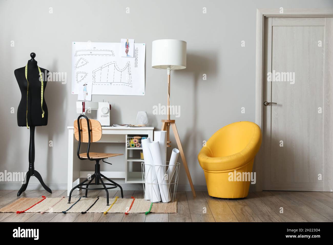 Tailor's workplace with sewing machine and mannequin in modern atelier ...