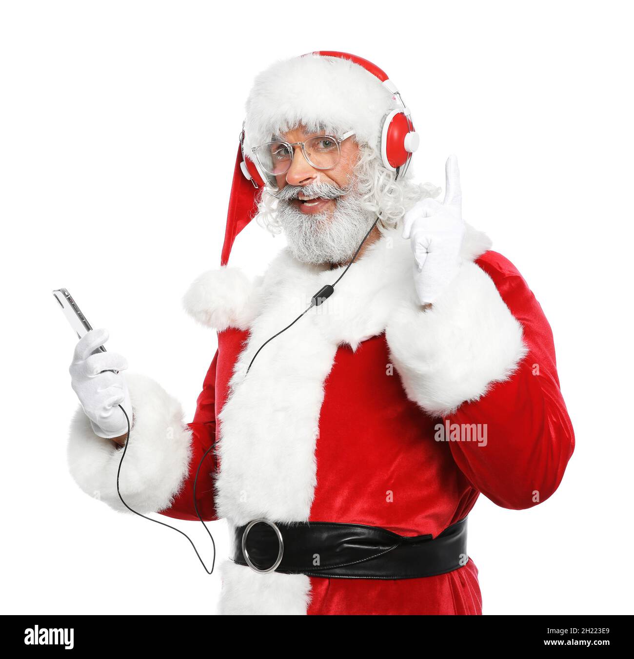 Santa Claus listening to Christmas music on white background Stock ...