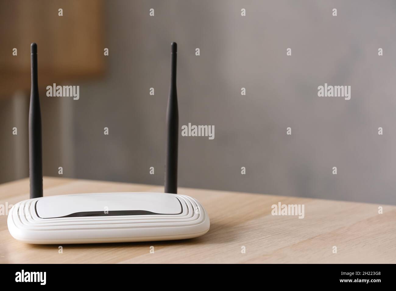 Modern wi-fi router on table in room Stock Photo - Alamy