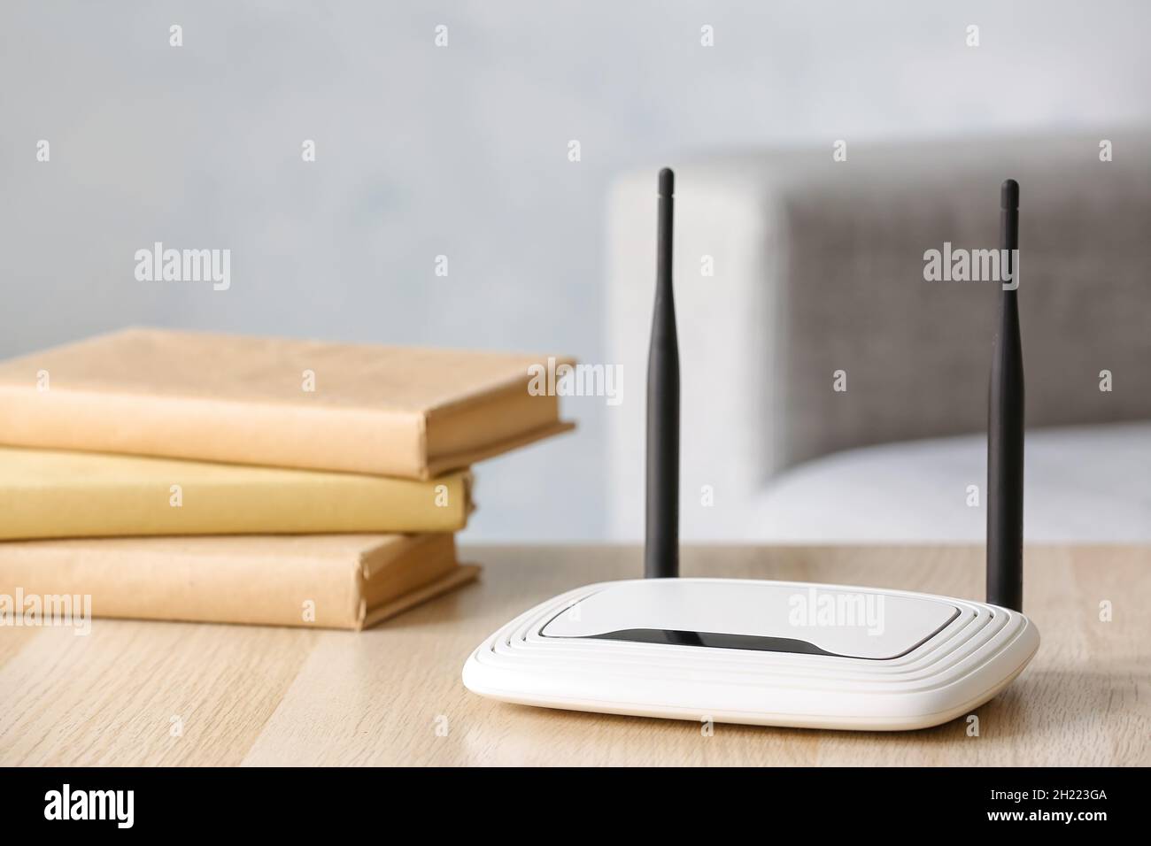 Modern wi-fi router on table in room Stock Photo - Alamy