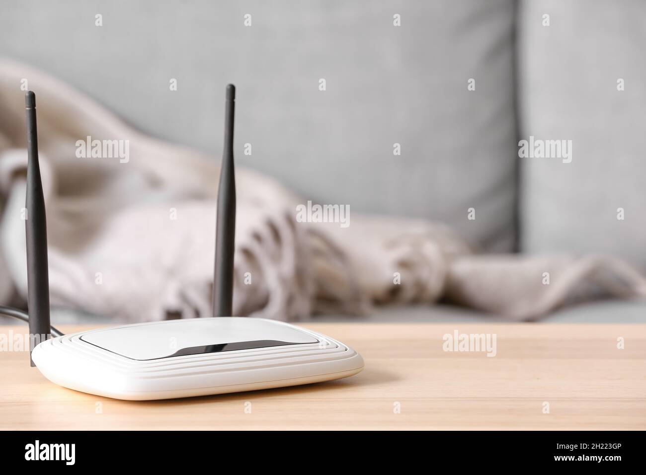 Modern wi-fi router on table in room Stock Photo - Alamy