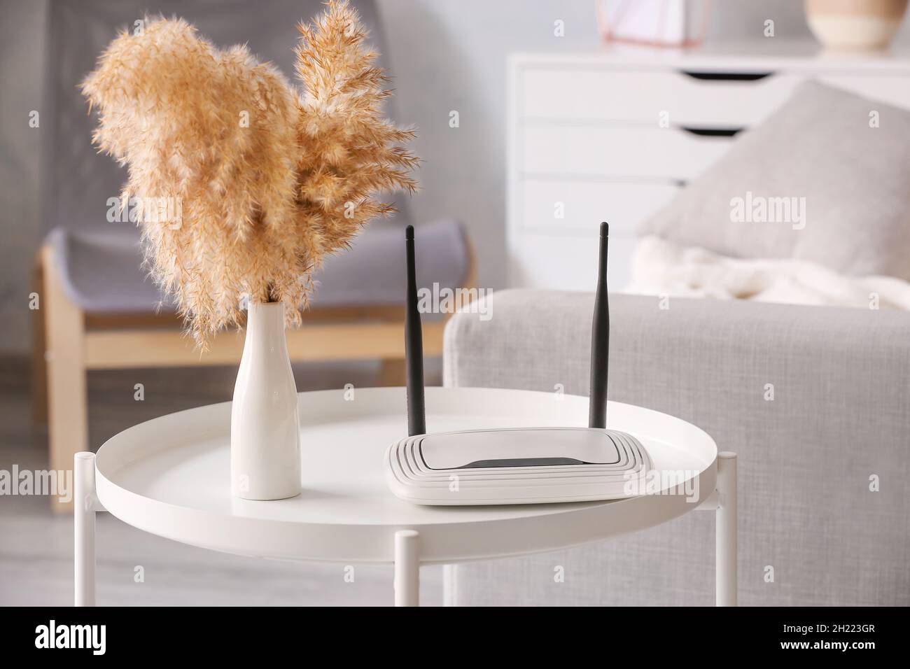 Modern wi-fi router on table in room Stock Photo - Alamy