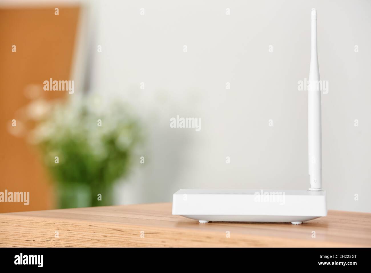 Modern wi-fi router on table in room Stock Photo - Alamy
