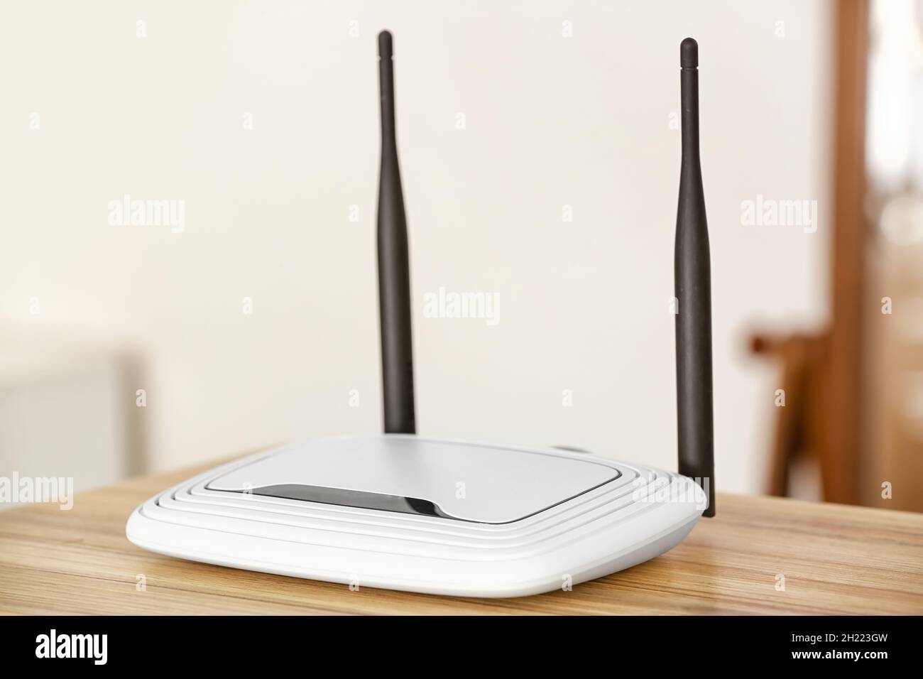 Modern wi-fi router on table in room Stock Photo - Alamy