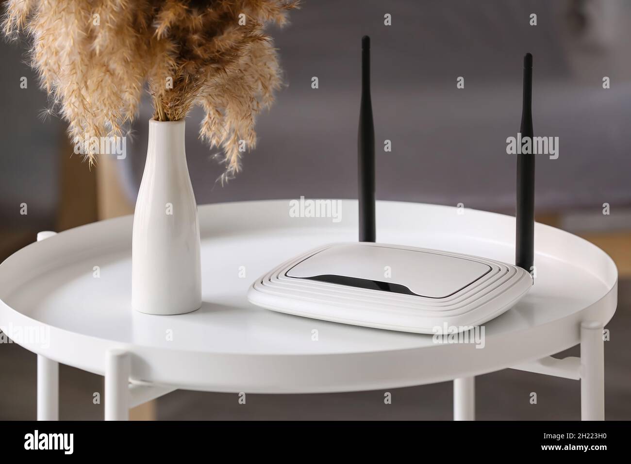 Modern wi-fi router on table in room Stock Photo - Alamy