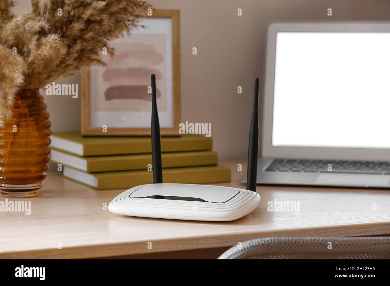 Modern wi-fi router on table in room Stock Photo - Alamy