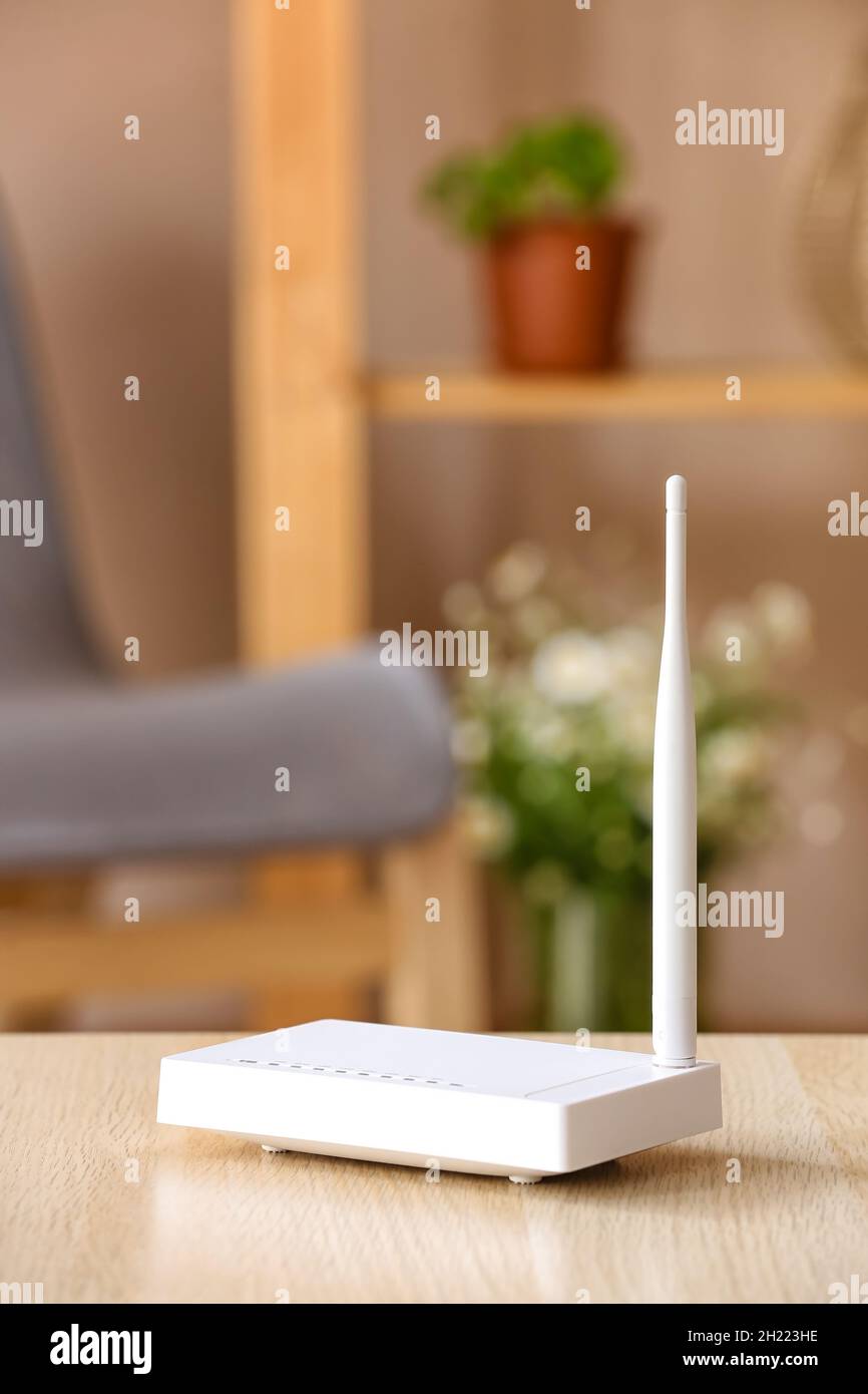 Modern wi-fi router on table in room Stock Photo - Alamy