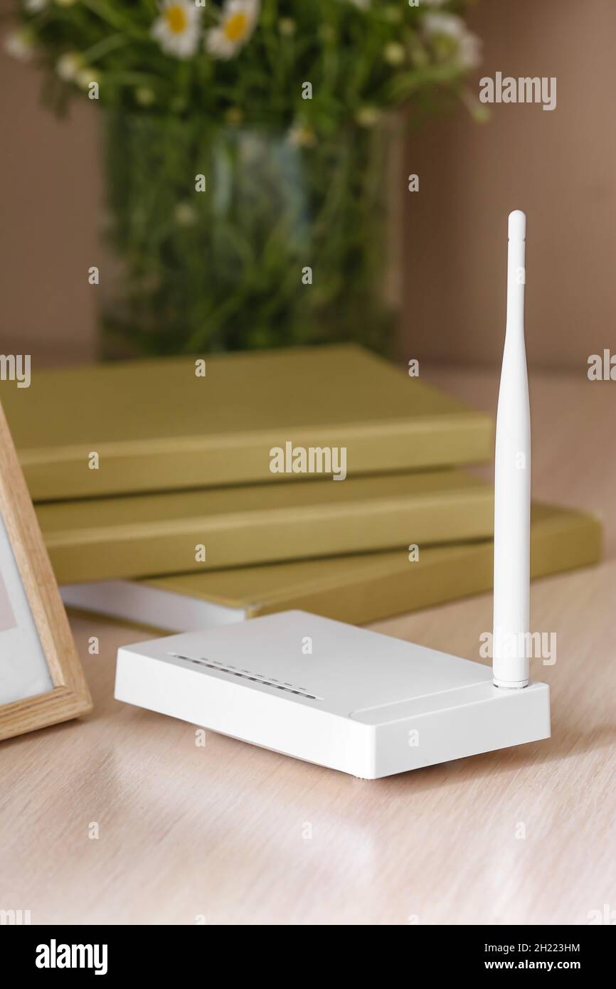Modern wi-fi router on table in room Stock Photo - Alamy