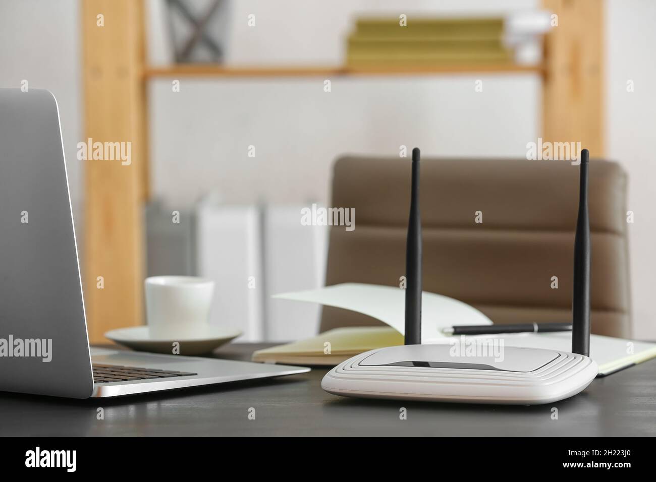 Modern wi-fi router on table in office Stock Photo - Alamy