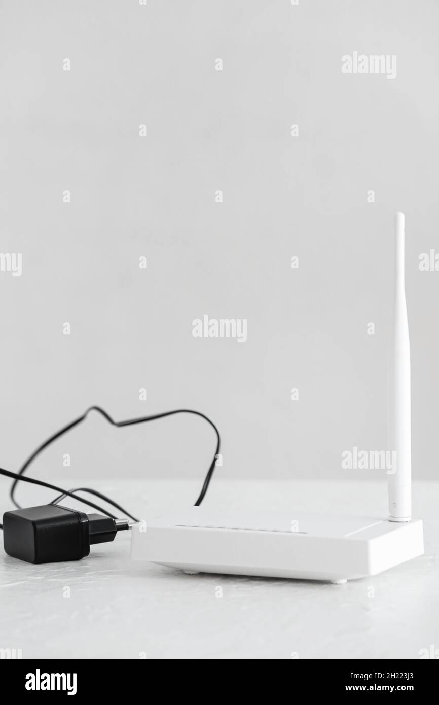 Modern wi-fi router on table near white wall Stock Photo - Alamy