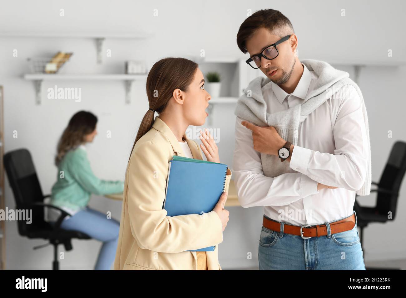 Workers gossiping about their colleague in office Stock Photo - Alamy