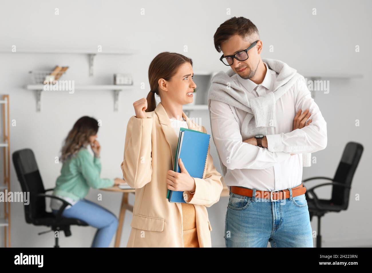 Workers gossiping about their colleague in office Stock Photo - Alamy