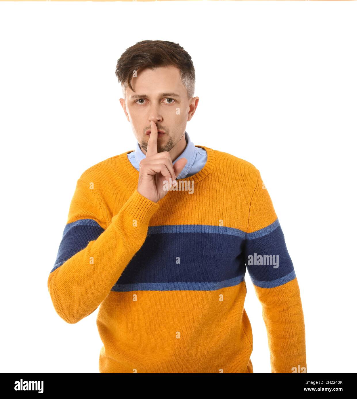 Man showing silence gesture on white background Stock Photo - Alamy