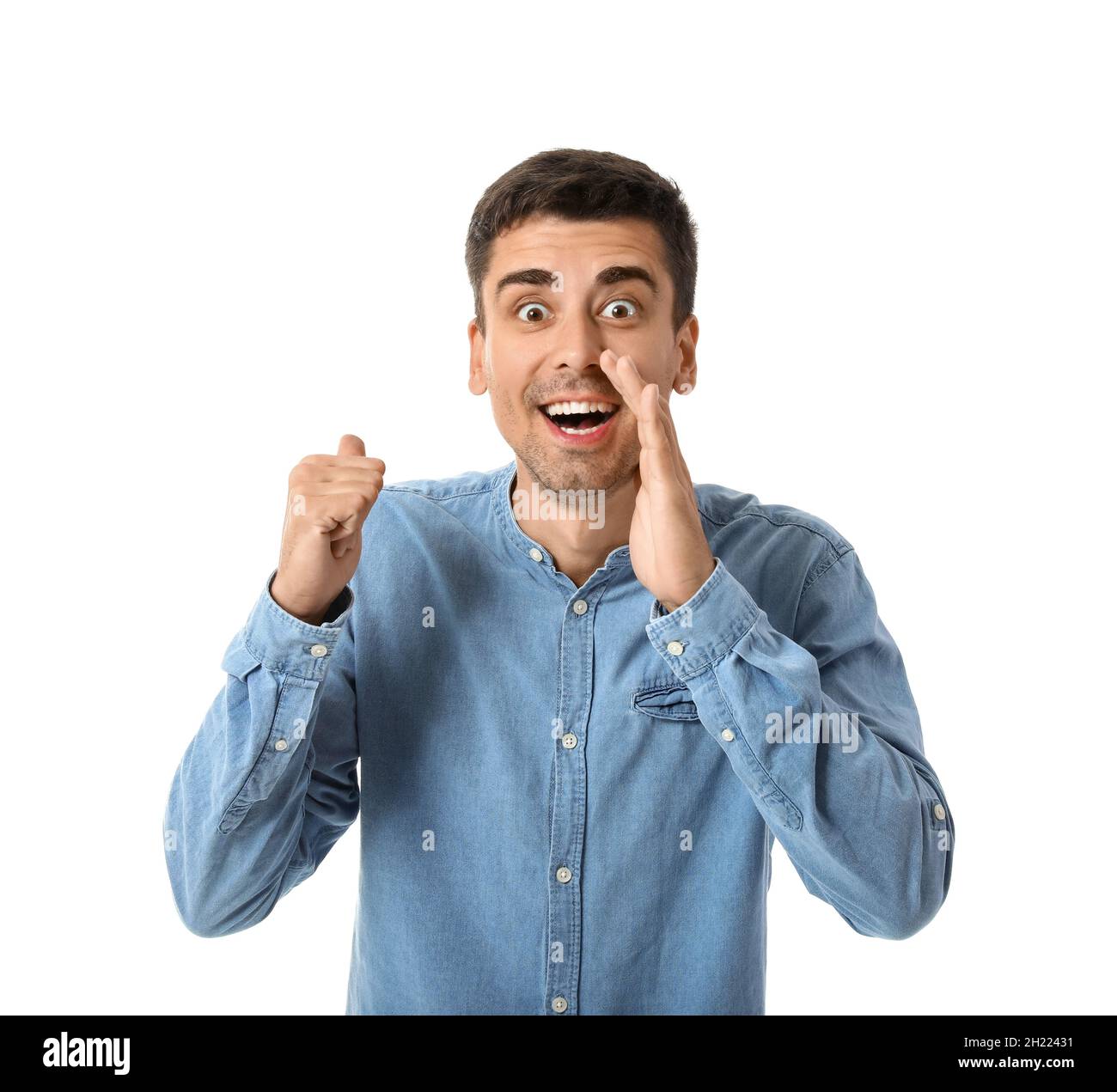 Surprised young gossiping man on white background Stock Photo - Alamy