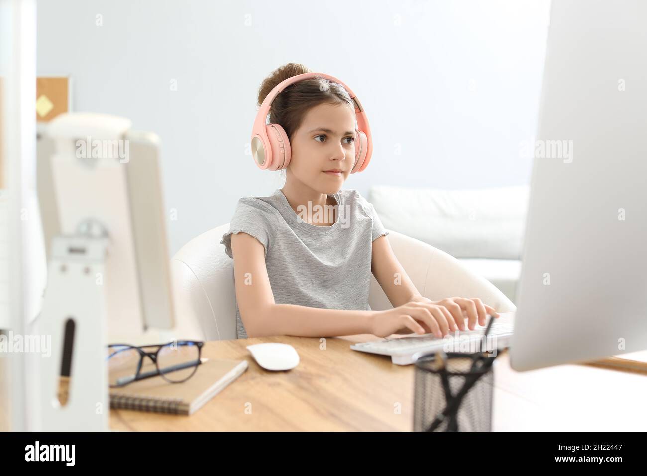 Cute little programmer using computer in office Stock Photo - Alamy