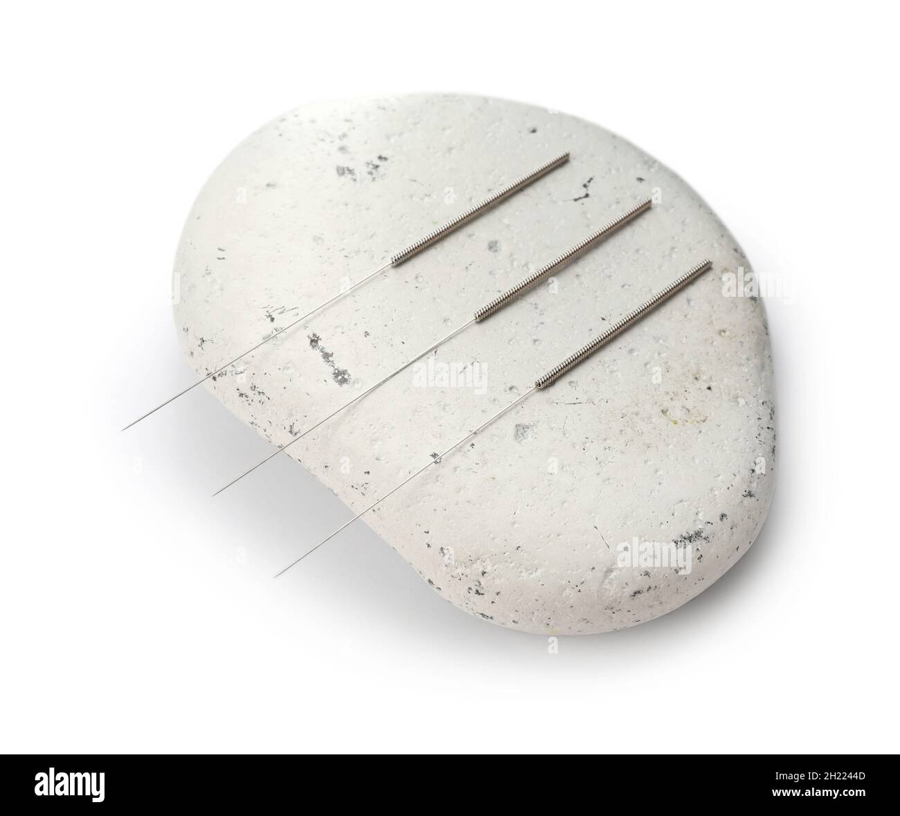 Needles for acupuncture and stone on white background Stock Photo - Alamy