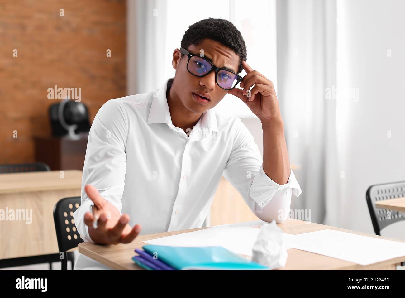 African-American student passing difficult exam at school Stock Photo ...