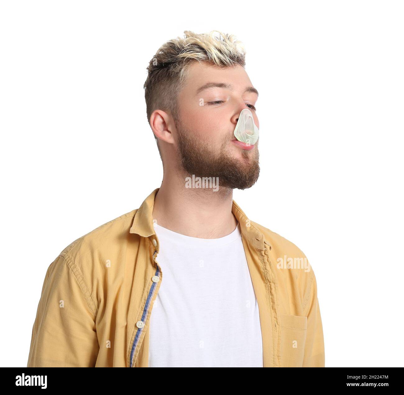 Young man with chewing gum on white background Stock Photo - Alamy