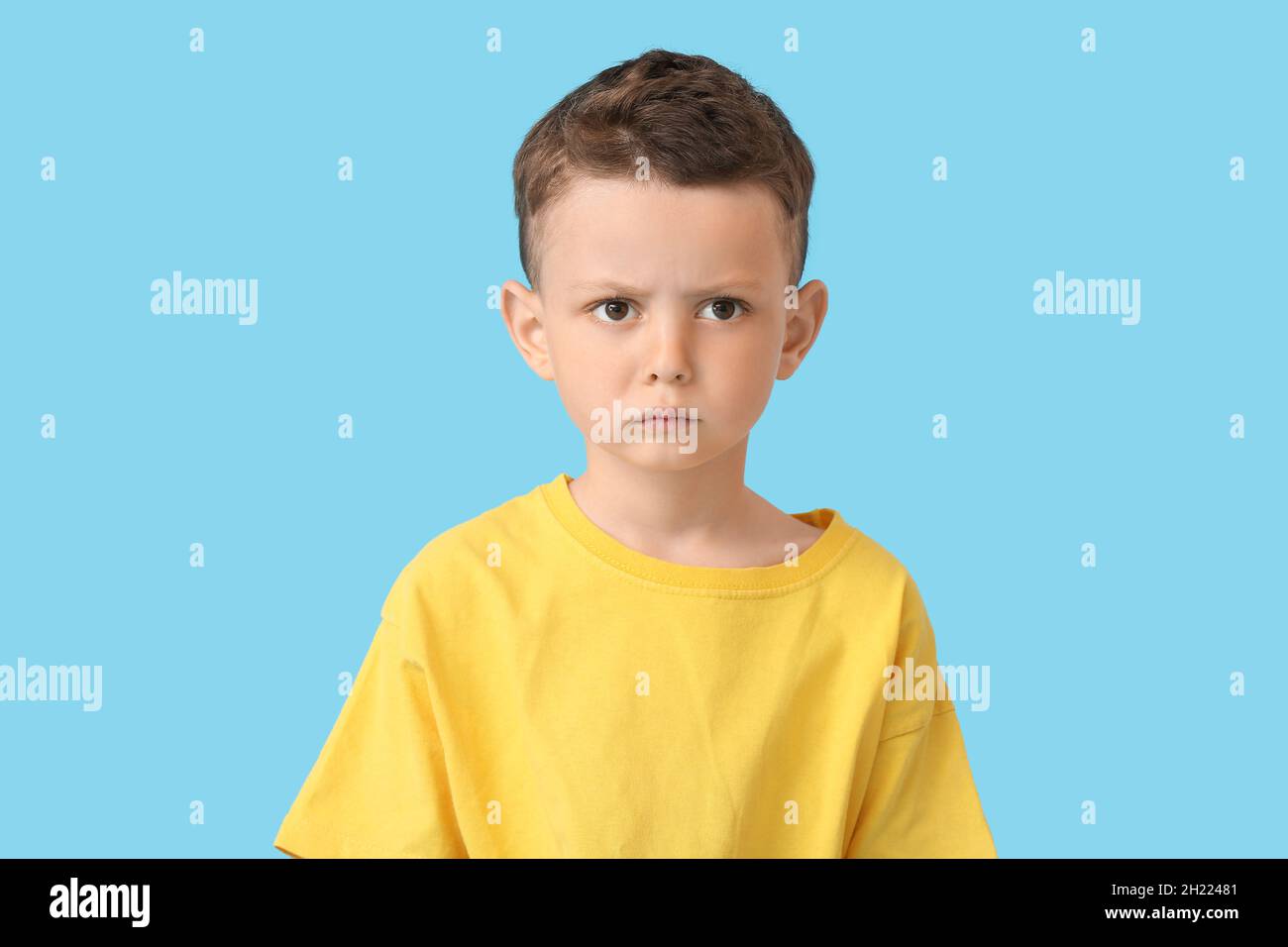 Portrait of frowning little boy on color background Stock Photo - Alamy