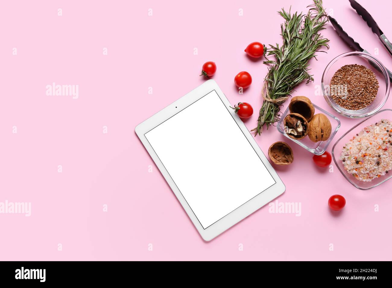 Digital recipe book and different ingredients on pink background Stock ...
