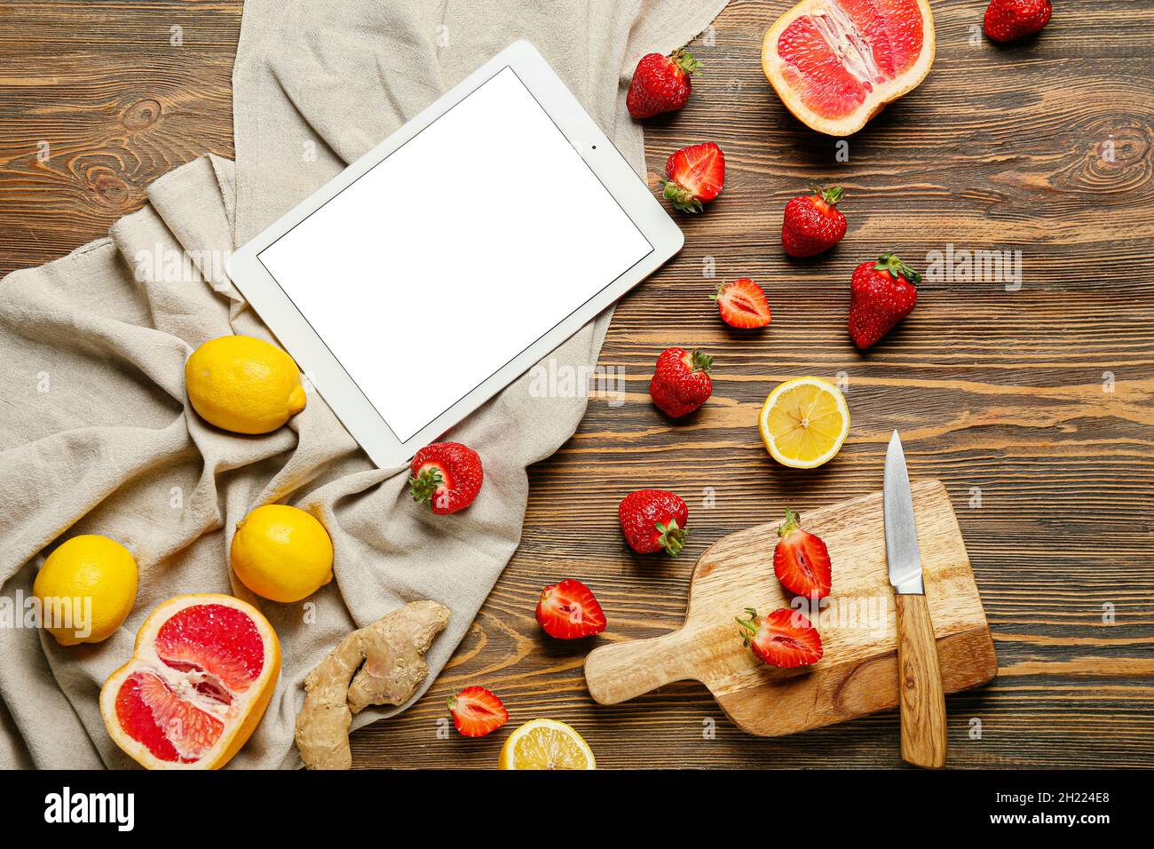 Different fruits and digital recipe book on wooden background Stock ...