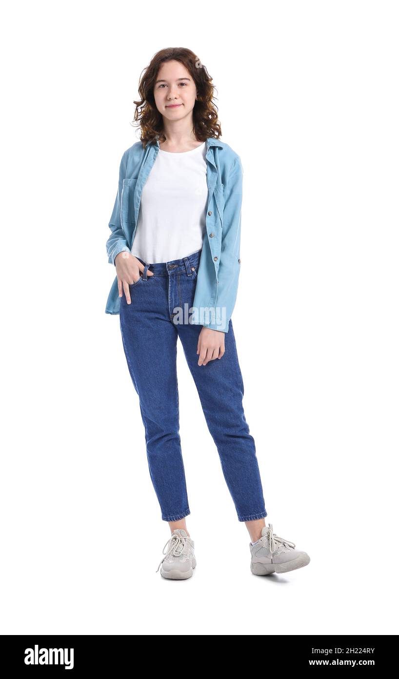 Pretty teenage girl in blue jeans on white background Stock Photo - Alamy