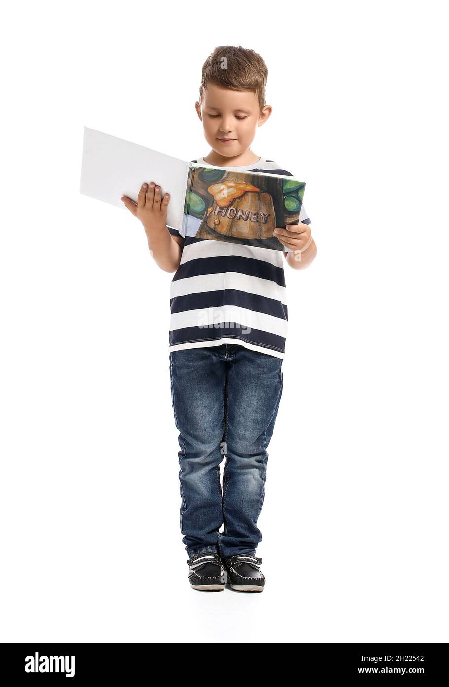 Cute little boy reading fairy-tale on white background Stock Photo - Alamy