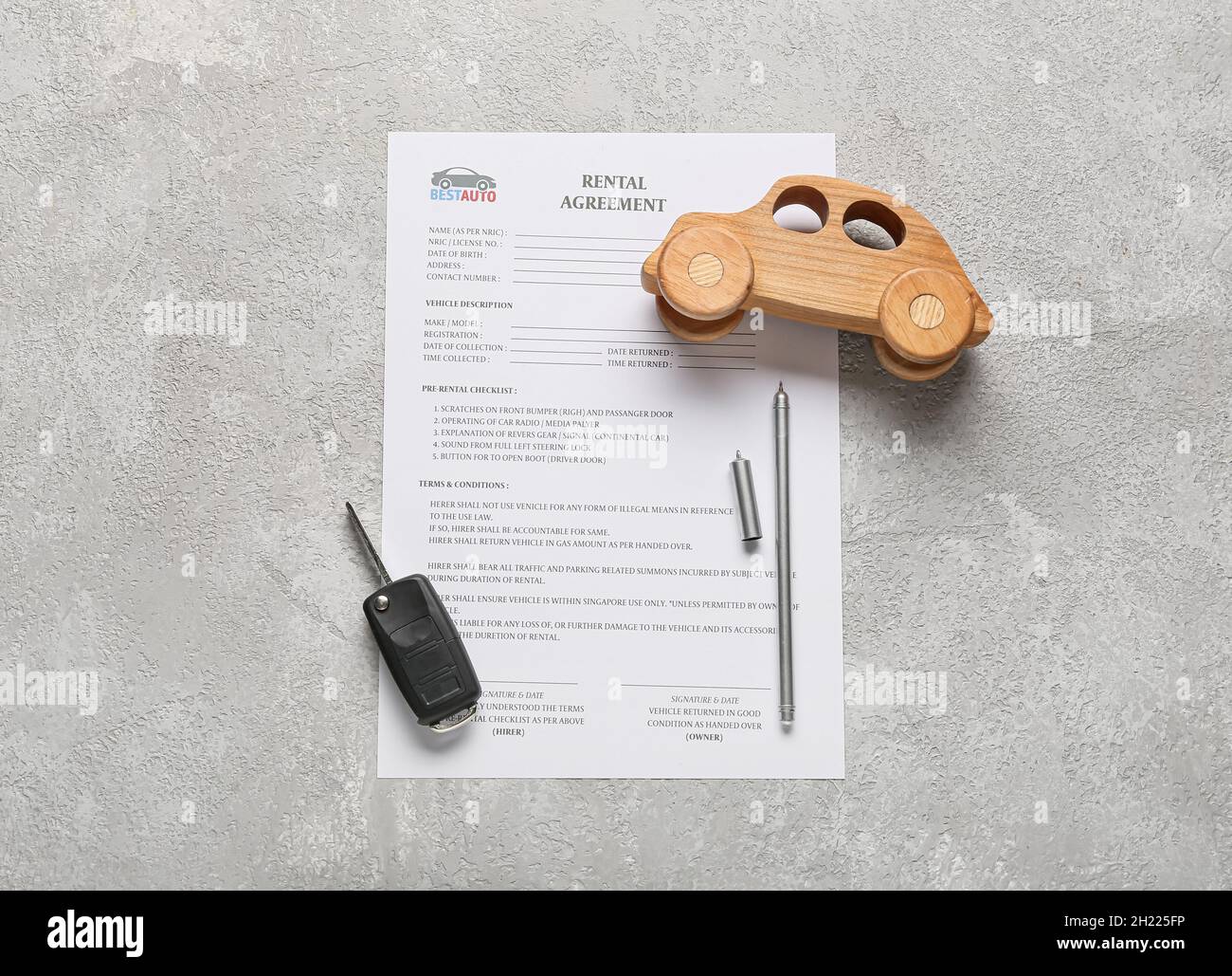 Rental agreement, car key, pen and wooden car on grey background Stock ...