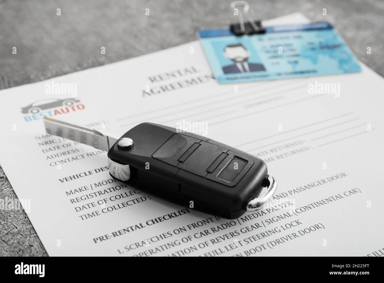 Car key, rental agreement and driver license on grey background ...