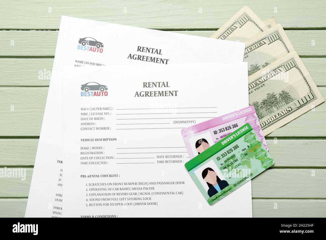Rental agreements, money and driver licenses on color wooden background ...