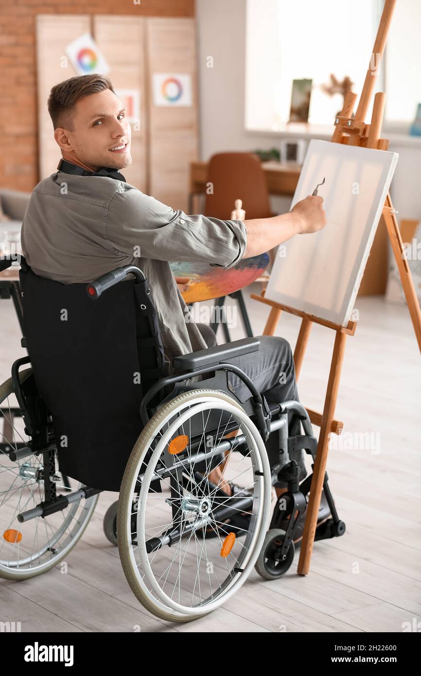 Young handicapped artist painting in workshop Stock Photo - Alamy