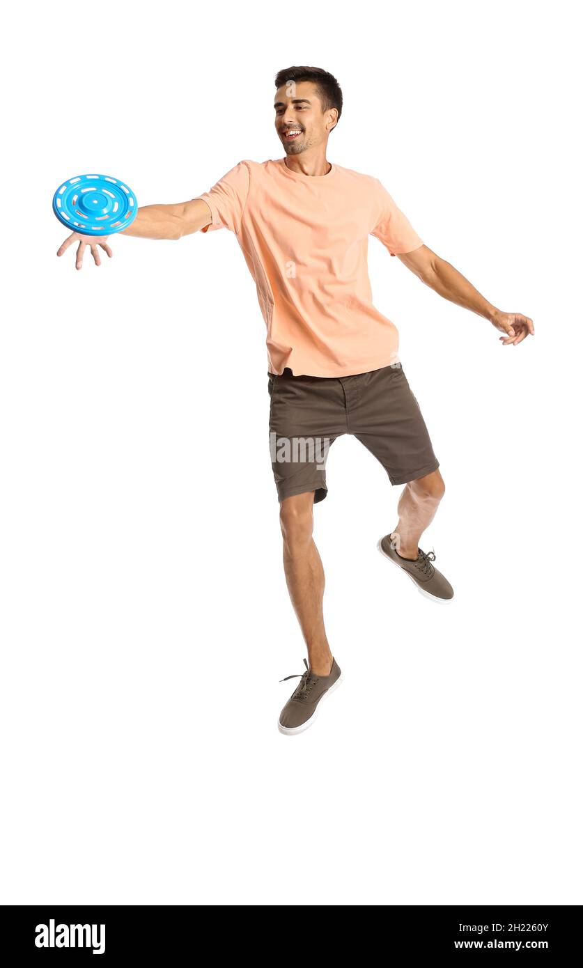 Young man catching frisbee on white background Stock Photo - Alamy