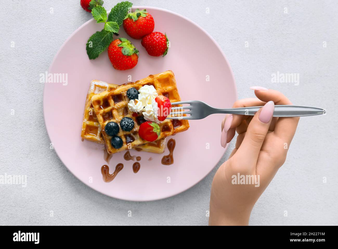 Young woman eating belgian hi-res stock photography and images - Alamy