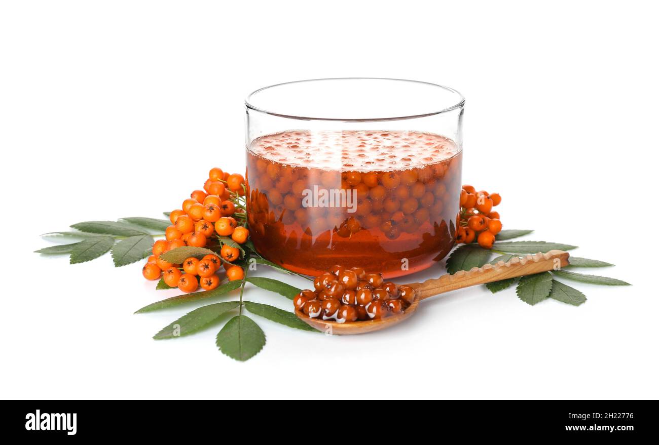 Bowl and spoon with tasty rowan jam on white background Stock Photo - Alamy