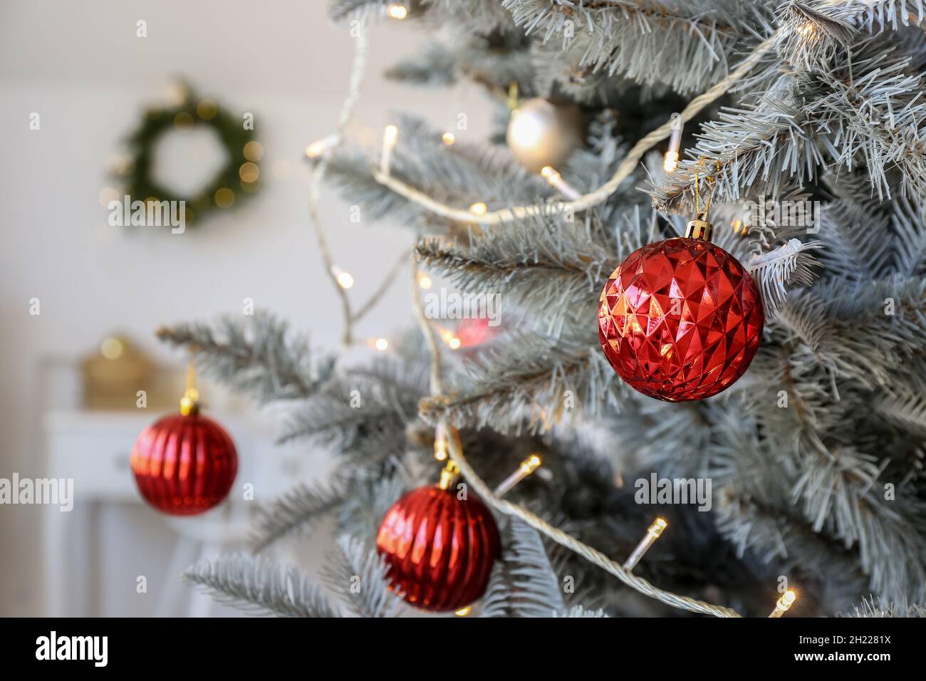Christmas tree with red balls in room, closeup Stock Photo - Alamy