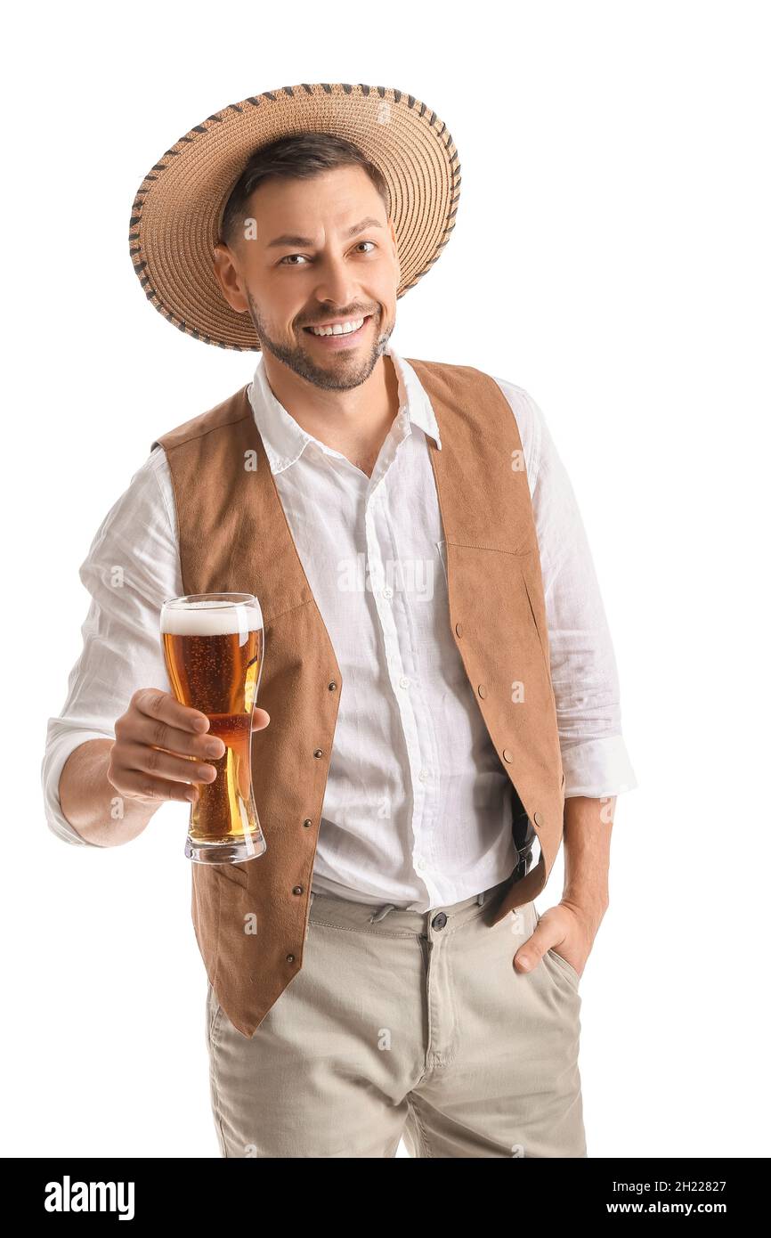 Young man in traditional German clothes with beer on white background ...