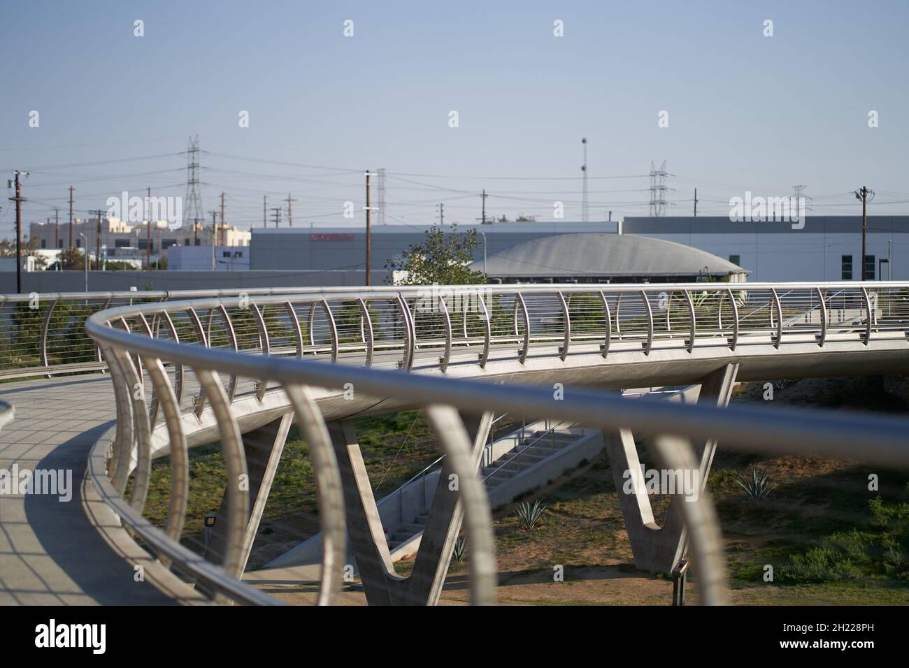 Empty pedestrian bridge under a blue sky on a sunny day Stock Photo - Alamy