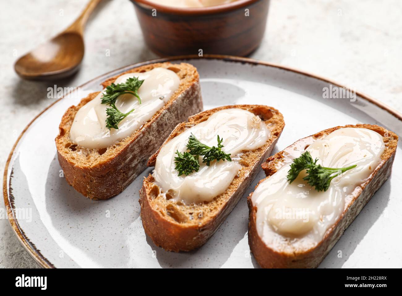 Plate of bread with lard spread on light background Stock Photo - Alamy