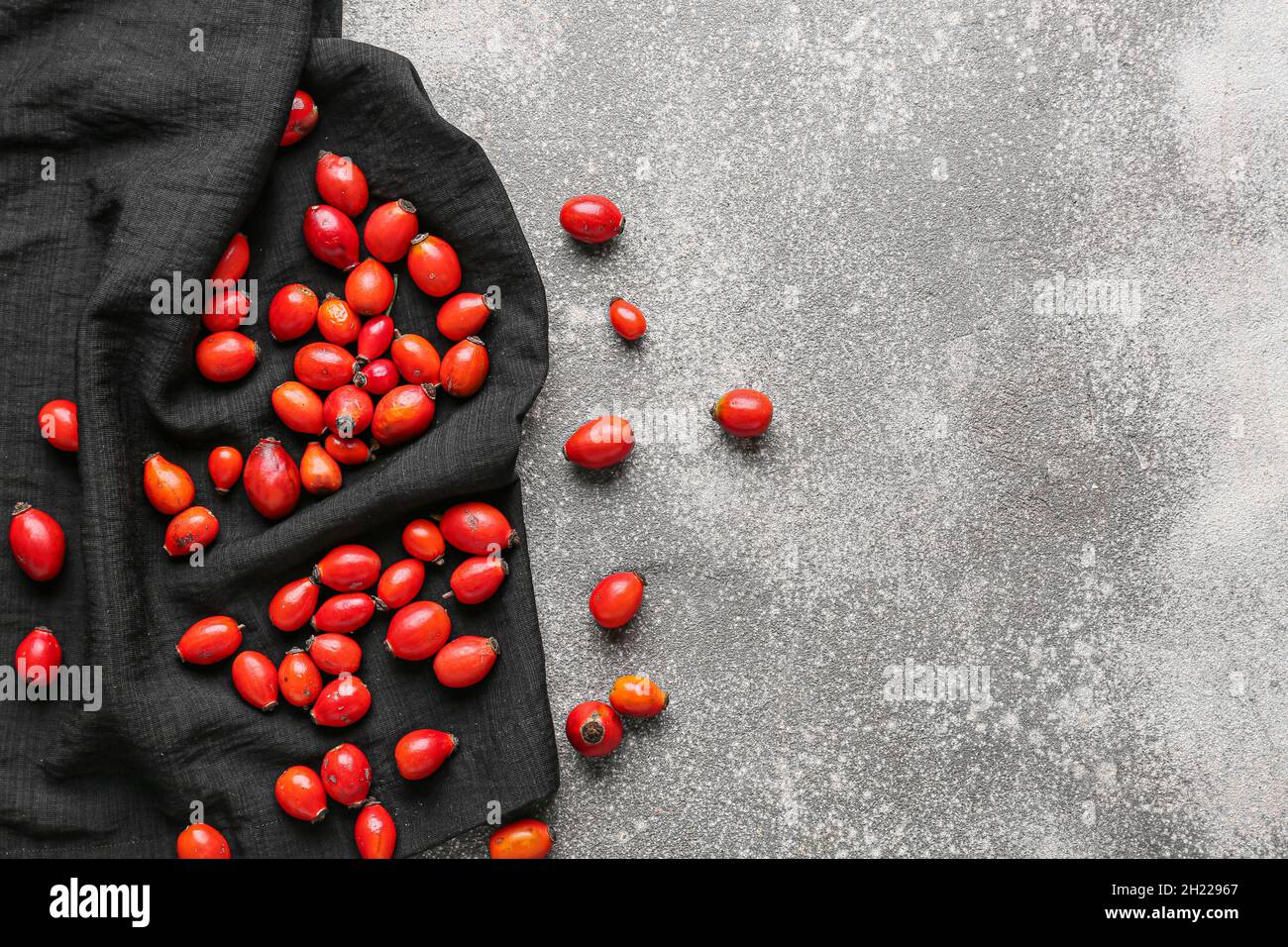 Fresh rose hip berries on grey background Stock Photo - Alamy