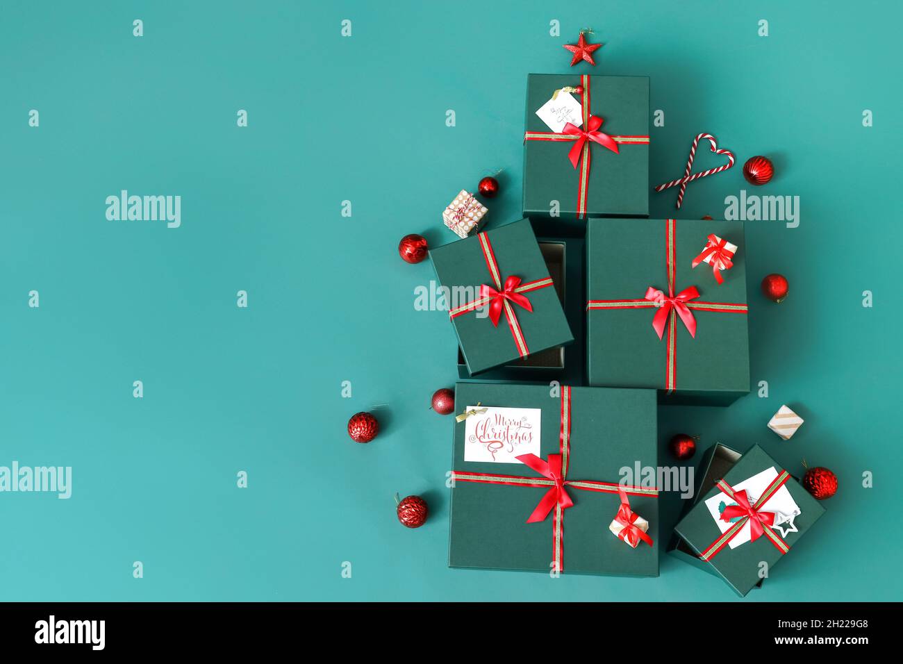 Christmas tree made of gift boxes and balls on green background Stock ...