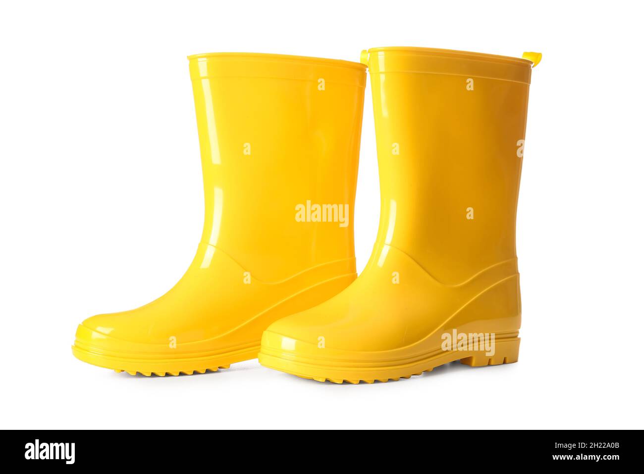 Pair of yellow rubber boots on white background Stock Photo - Alamy